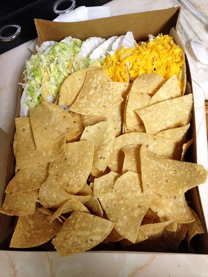 Chip abundance that would make Marie Kondo nervous. The generous heap of chips, cheese, and lettuce is Tito's way of saying "we care."