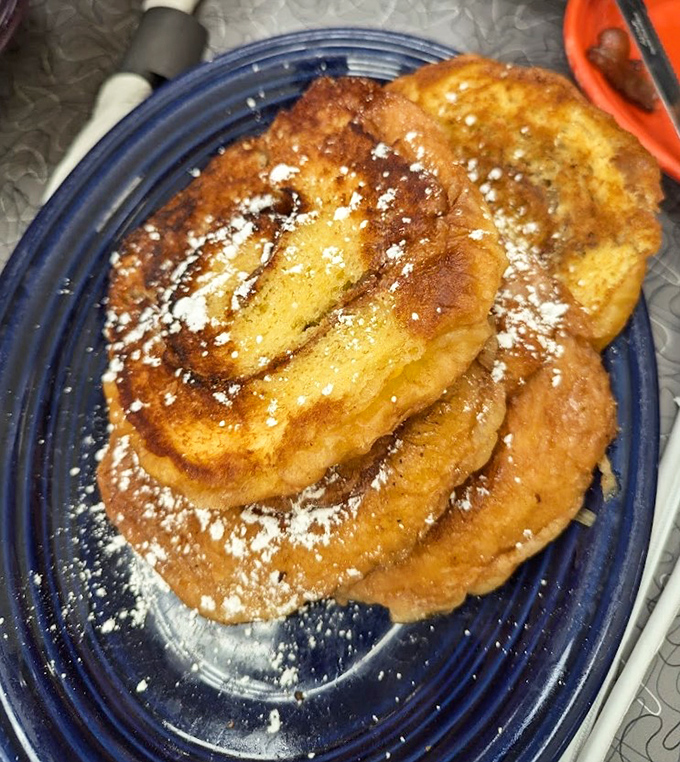 French toast that could make a Parisian jealous. Dusted with powdered sugar and stacked high enough to require a building permit.