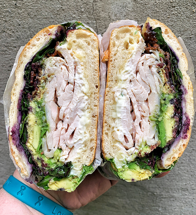 Layer upon layer of turkey, avocado and greens&mdash;this club sandwich isn't just stacked, it's architecturally sound enough to impress Frank Gehry. 