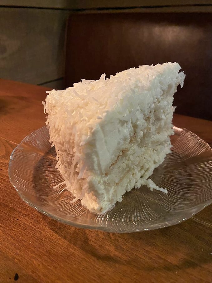 A slice of coconut cake that would make your grandmother both proud and jealous. Those layers aren't just dessert&mdash;they're architecture.