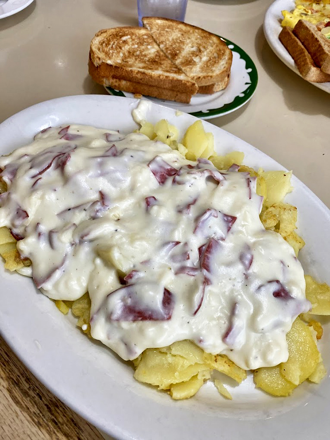 Creamed chipped beef blanketing golden home fries&mdash;comfort food so nostalgic it should come with a time machine back to your childhood.