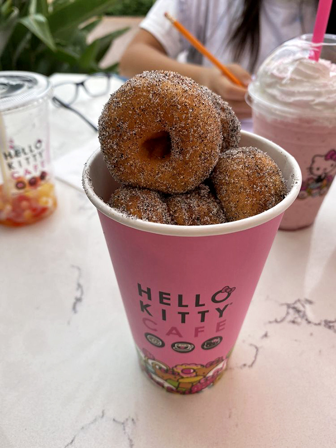 Sugar-dusted donuts stacked like edible poker chips in a game where everyone wins. The house special that has adults lining up like kids on Saturday morning.
