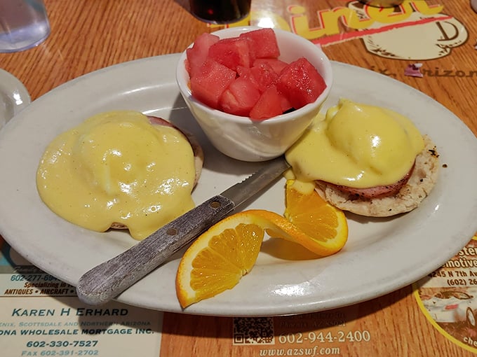 Eggs Benedict done right: perfectly poached eggs draped in sunshine-yellow hollandaise with a side of juicy watermelon to cut the richness.