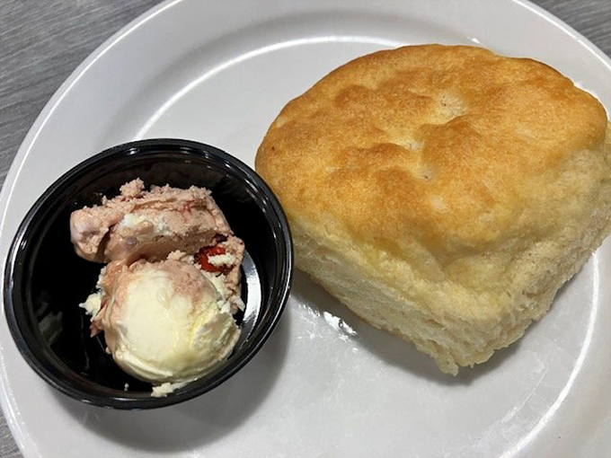 The humble biscuit, elevated to art form. That butter container might as well be labeled "Happiness Spread" for what it's about to do to that cloud-like creation.