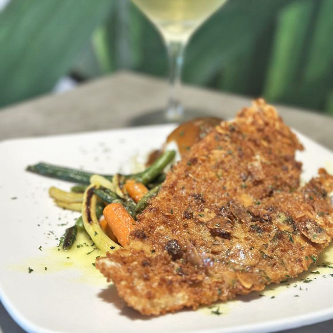 Crispy, golden perfection meets fresh vegetables in this flounder dish that would make even seafood skeptics reconsider their life choices.