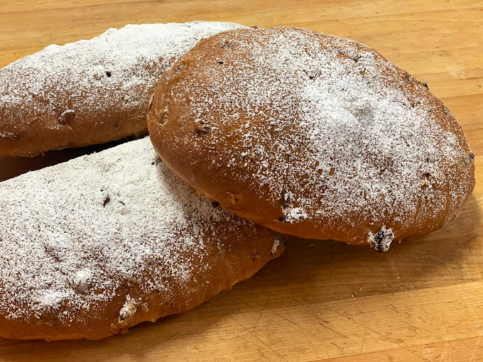 Rustic sourdough loaves dusted with flour like they've been kissed by the baking gods themselves.