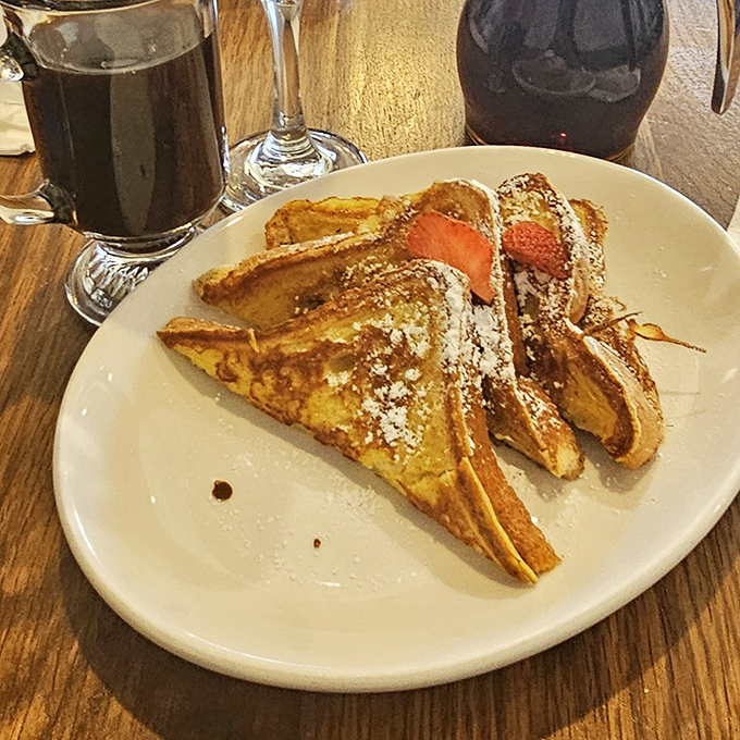 French toast that makes you question why you ever settled for regular bread. The powdered sugar snowfall is just showing off.