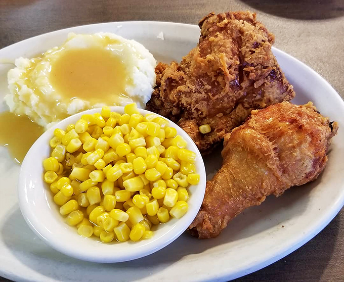 Fried chicken that would make Colonel Sanders question his life choices, served alongside creamy mashed potatoes and sweet corn that tastes like summer.