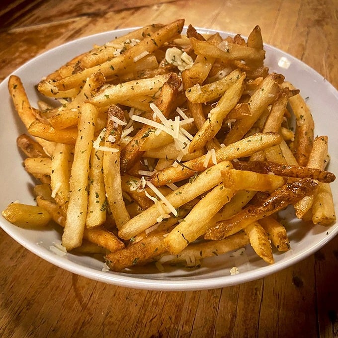 Fries that achieve the golden trifecta: crispy exterior, fluffy interior, and just enough Parmesan to make you feel fancy while eating with your fingers.