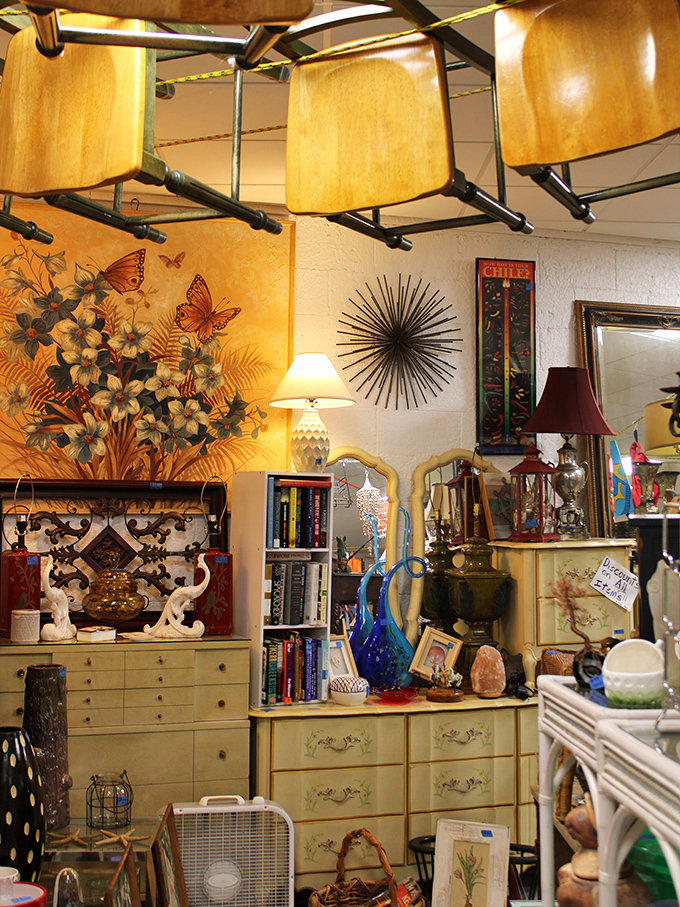 Wooden chairs suspended from the ceiling create an Alice-in-Wonderland effect above carefully curated vignettes of vintage treasures.