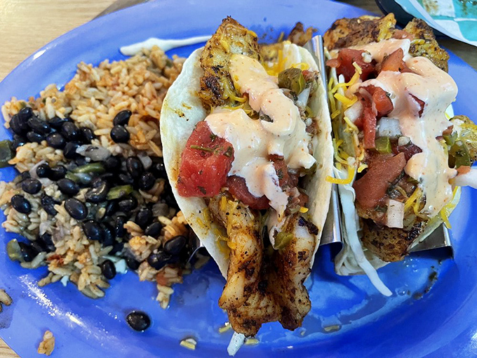 These grouper tacos don't need a passport to blend cultures. Blackened Florida fish meets Mexican tradition with a side of rice and beans that's pure vacation on a plate.