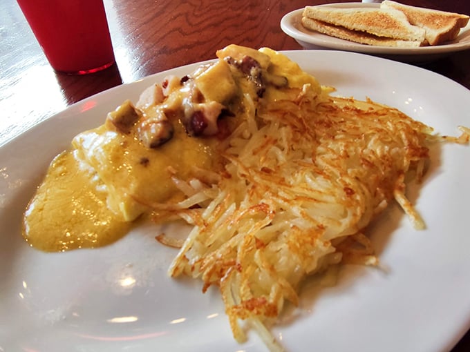 Golden hash browns with the ideal crisp-to-tender ratio, crowned with an omelet that's seen just the right amount of cheese. Breakfast architecture at its finest.