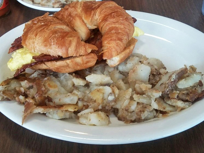 A croissant sandwich that makes the French jealous, paired with home fries that could make Idaho reconsider its potato priorities.