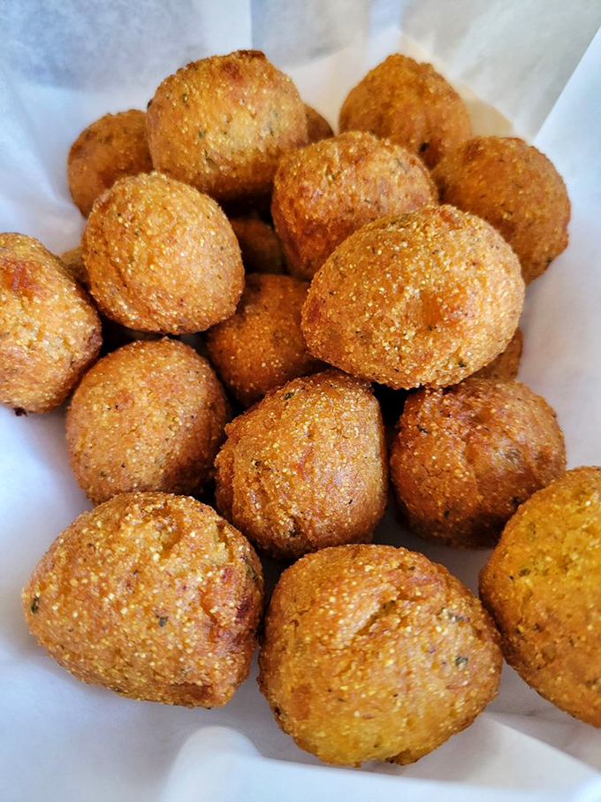 Hush puppies so perfectly golden they could win medals. These cornmeal spheres of happiness disappear from the table faster than magician's tricks.