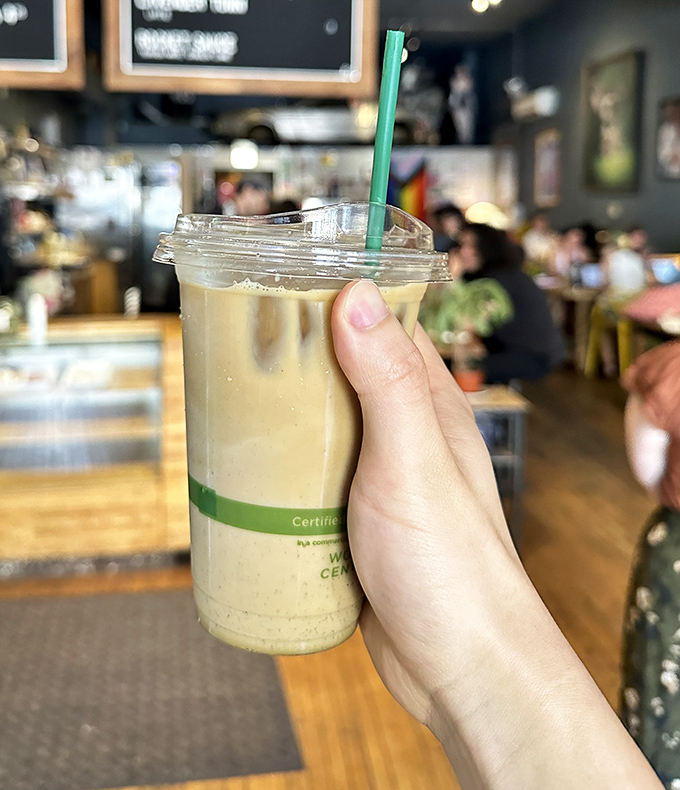Someone's holding liquid gold&mdash;an iced latte that promises to transform your afternoon slump faster than Clark Kent in a phone booth.