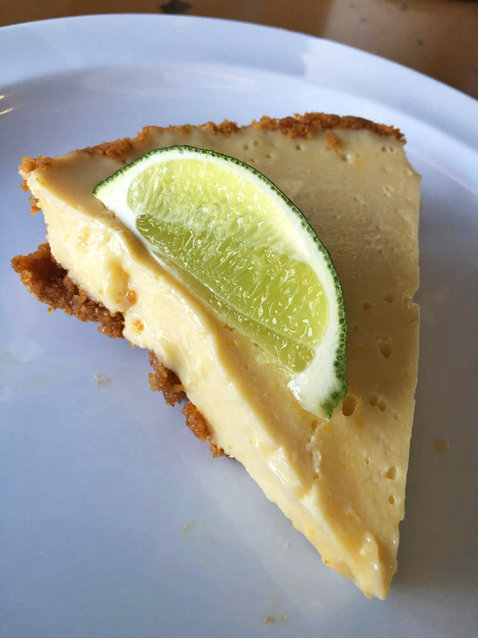 Key lime pie with that perfect balance of sweet and tart&mdash;a citrus-kissed finale that cuts through barbecue richness like a well-timed punchline.