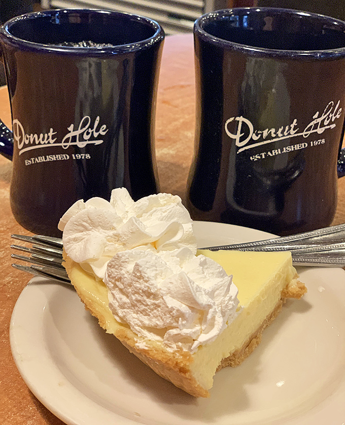 Key lime pie with clouds of whipped cream flanked by signature navy blue mugs&mdash;Florida's official "I deserve this" afternoon indulgence.