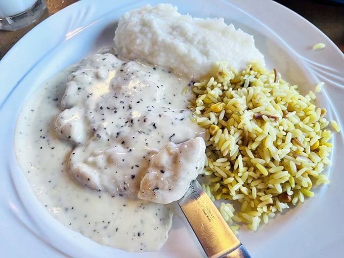 Comfort food gets the coastal treatment&mdash;tender chicken swimming in a velvety sauce alongside perfectly cooked rice. No passport required for this flavor journey.