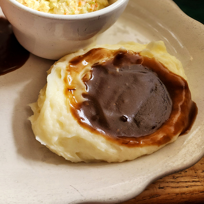 Mashed potatoes sculpted into a perfect gravy reservoir. Architecture this impressive usually requires a permit and safety inspection.