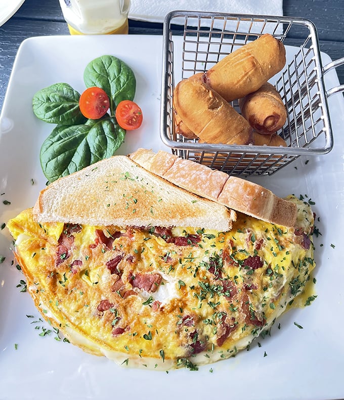 This isn't just an omelet&mdash;it's a fluffy golden pillow of breakfast joy, served with what might be the world's most perfectly crispy tater tots.