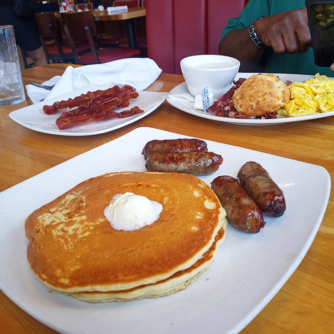Golden pancakes with a perfect pat of butter slowly melting into their fluffy depths. Those sausage links are just showing off.