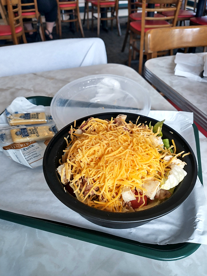 This salad has more cheese than your uncle's collection of dad jokes. A mountain of shredded cheddar turns healthy eating into happy eating.