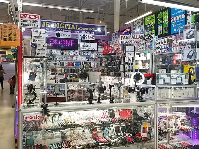 The electronics bazaar glows with digital promises. Yesterday's iPhone cases and tomorrow's vintage tech collectibles share the same glass kingdom.