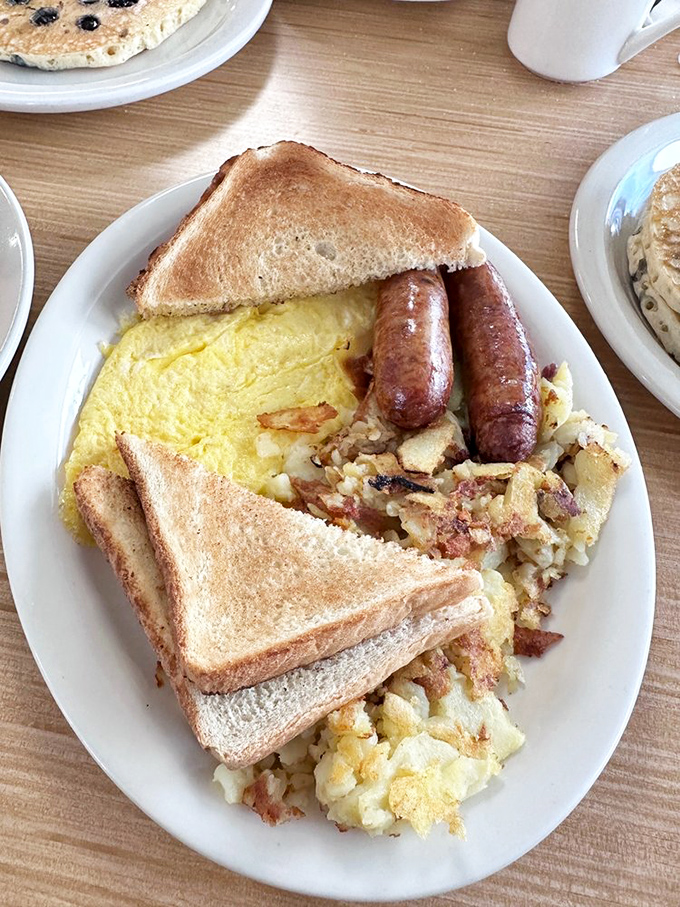 The breakfast platter of champions. Toast, eggs, sausage, and home fries&mdash;proof that sometimes the classics endure because they're simply perfect.