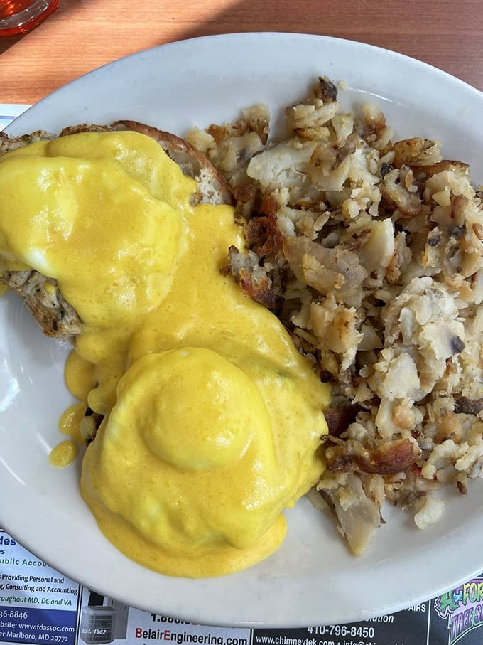 Eggs Benedict gets the Maryland treatment with hollandaise cascading over crab cakes like sunshine over the Chesapeake Bay.