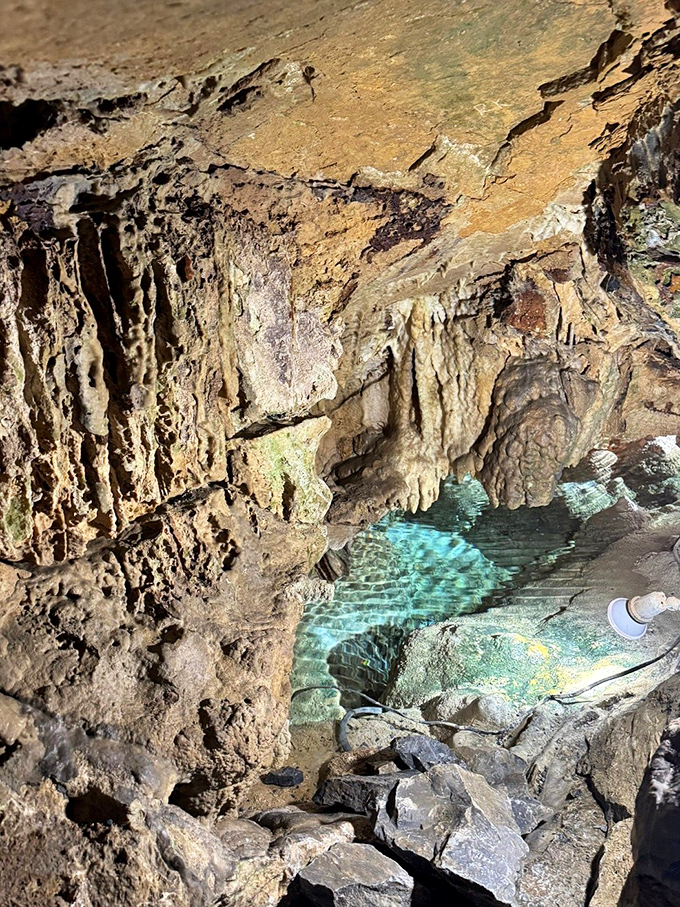 Crystal-clear waters create nature's perfect mirror, reflecting the cavern ceiling with such precision you'll question which way is up.