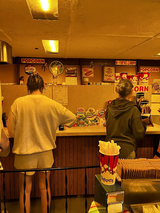 The concession stand&mdash;where movie magic meets comfort food. These patrons know that drive-in popcorn somehow tastes better than anywhere else on earth.