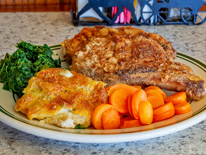Country cooking perfection on a plate. That pork chop has the kind of golden crust that makes you want to applaud.