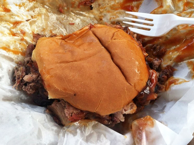 A pulled pork sandwich that doesn't need fancy presentation &ndash; just a soft bun struggling heroically to contain meat that's been smoking longer than some drivers have had licenses.