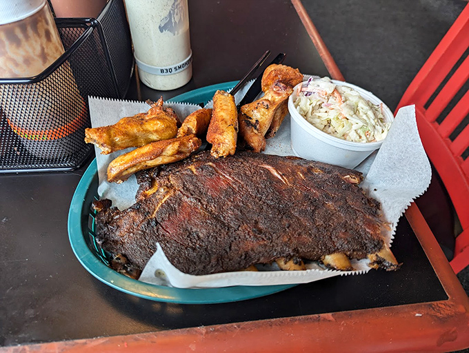 Ribs with that perfect mahogany crust, served with coleslaw and fries&mdash;a barbecue trifecta that would make even the most stoic pitmaster shed a tear of joy.