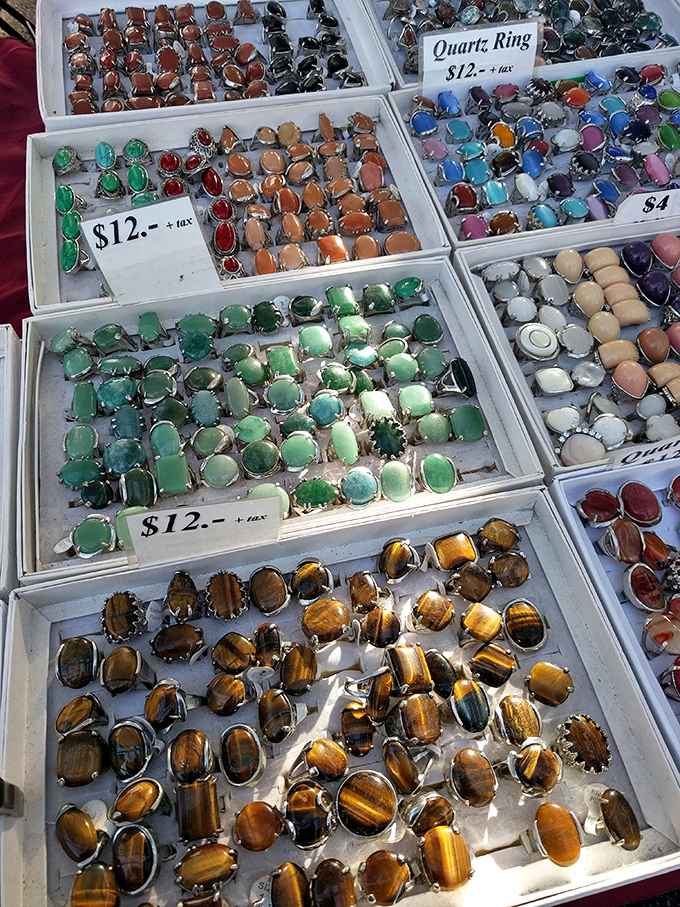 Gemstone rings sparkle in their velvet-lined display cases. Somewhere between treasure chest and jewelry box, this table makes magpies of us all.