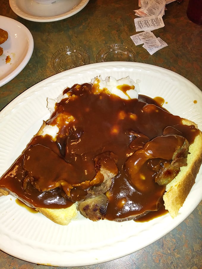 Open-face roast beef that doesn't know the meaning of portion control. That gravy river flowing over tender meat and bread is Midwestern comfort defined.