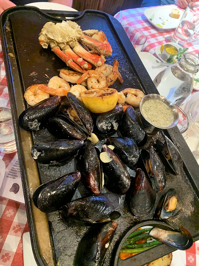 The seafood skillet arrives like Neptune's personal feast&mdash;mussels, crab legs, and shrimp glistening with garlic butter that demands to be sopped up.