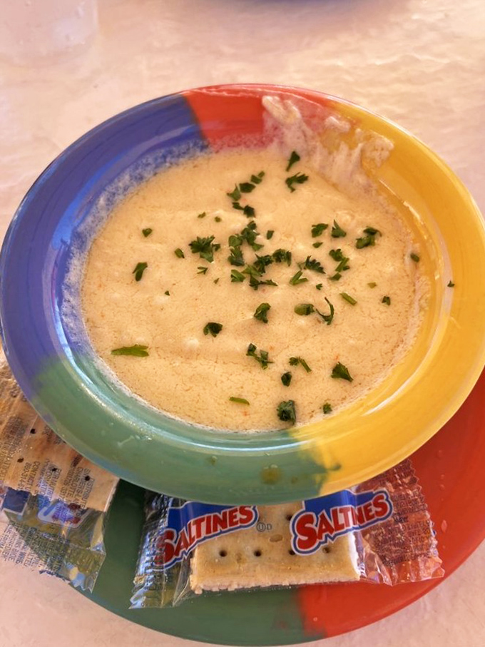 Soup that launched a thousand spoons! The legendary She-Crab soup arrives like a creamy cloud with delicate herbs floating on top&mdash;comfort in a colorful bowl.