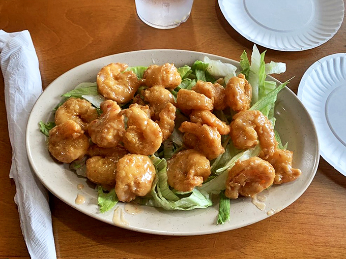 Golden-fried shrimp perched on a bed of lettuce &ndash; little crispy treasures that make you wonder why you'd ever order anything else.