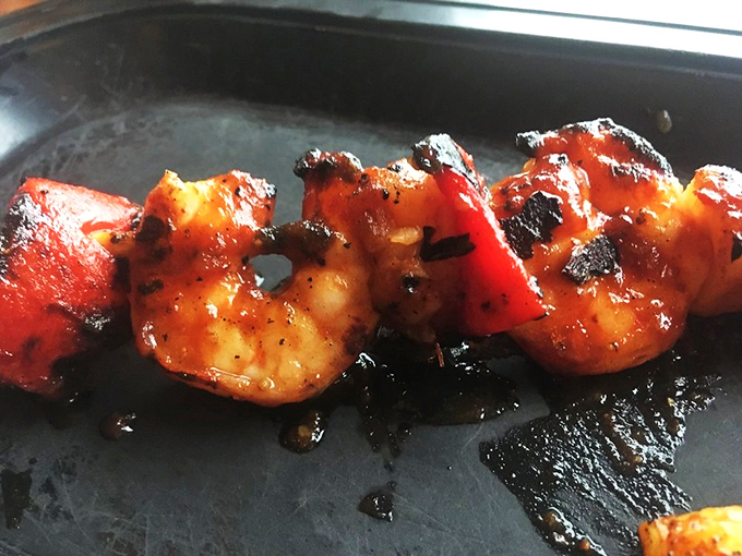 Shrimp that took a detour through flavor town before arriving at your table, charred to perfection and ready for their close-up.