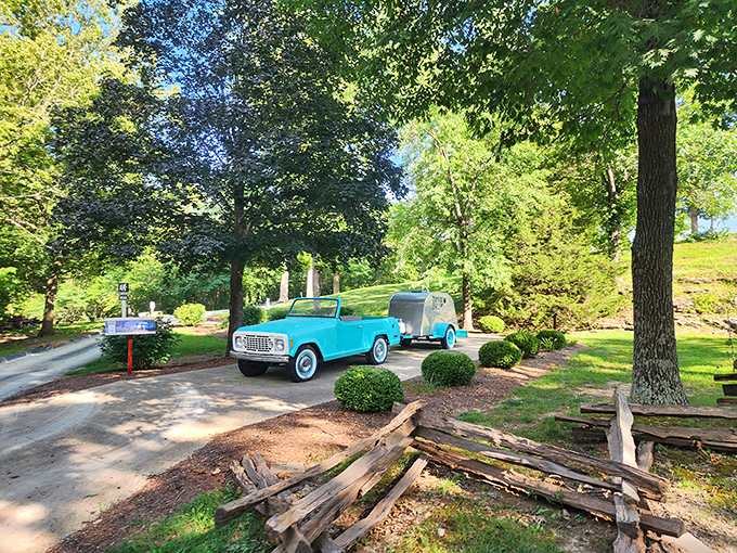 Road trip nostalgia meets underground adventure. This classic blue Jeepster on display evokes a time when family vacations meant discovery, not just destination. 