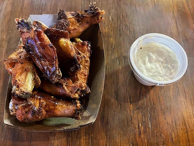 Smoke-kissed wings glisten with a lacquer that whispers of hours spent in hickory's embrace, served with a side of cool relief.