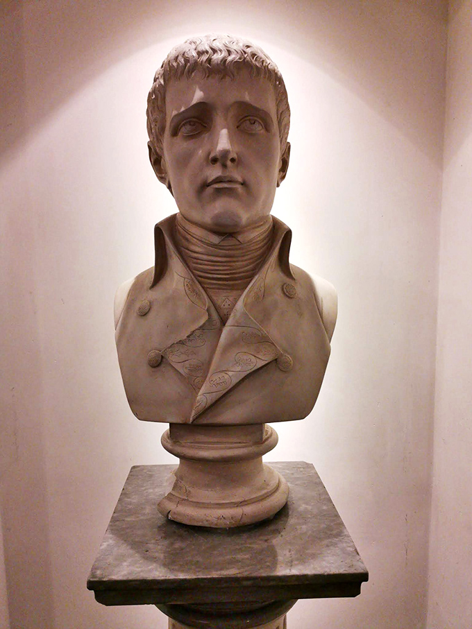 A classical bust that seems to ask, "Do you believe everything you read?" &ndash; the perfect sentinel for a museum that playfully blurs fact and fiction.