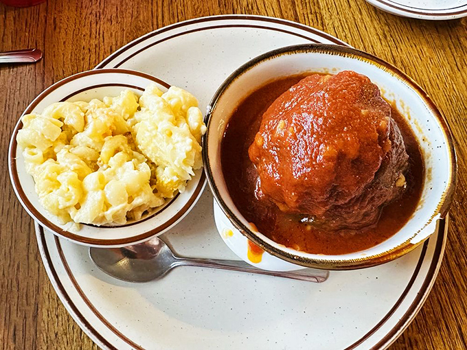 Meatloaf smothered in rich gravy alongside creamy mac and cheese&mdash;the kind of plate that makes you want to hug the chef afterward.