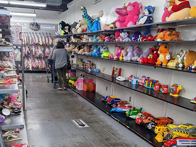Stuffed animal adoption center where plush creatures patiently wait for their forever homes. That pink elephant has seen things.