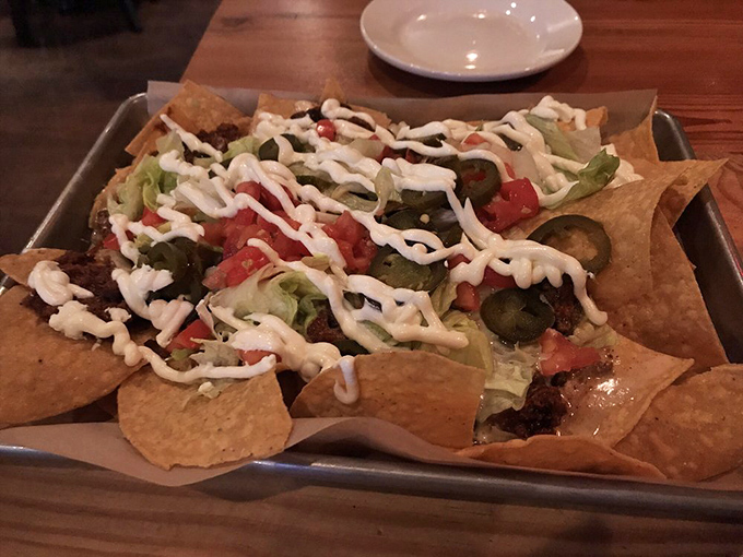 Nachos that require a strategy to eat &ndash; each chip a carefully engineered delivery system for the perfect ratio of toppings, cheese, and that zigzag of creamy sauce.