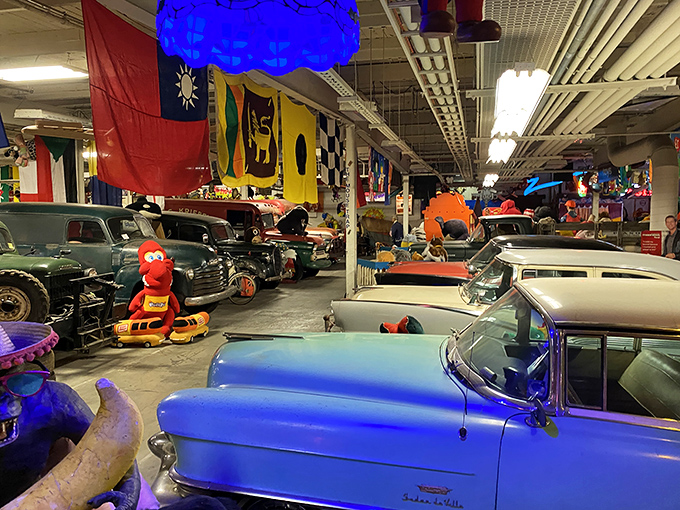 Classic cars share space with cartoon characters in this automotive paradise. That blue Cadillac probably has stories to tell.