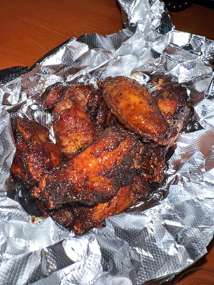 These aren't just wings; they're smoke-kissed flavor bombs with a mahogany sheen that makes grown adults weep with joy.