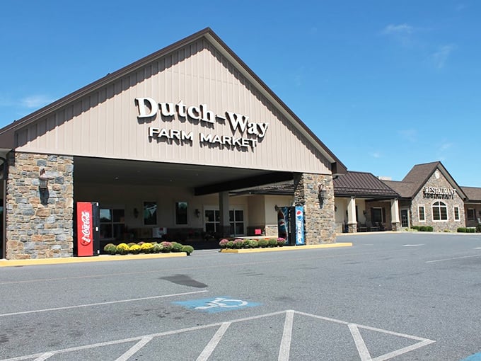Dutch-Way Farm Market's stone entrance stands proudly against blue skies. Your one-stop shop for groceries and gut-busting goodness.