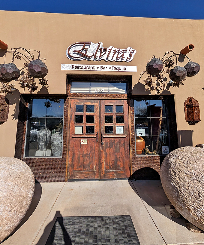 Elvira's dramatic entrance with massive stone spheres says "this isn't just dinner&mdash;it's an experience." Adobe walls hiding culinary artistry.